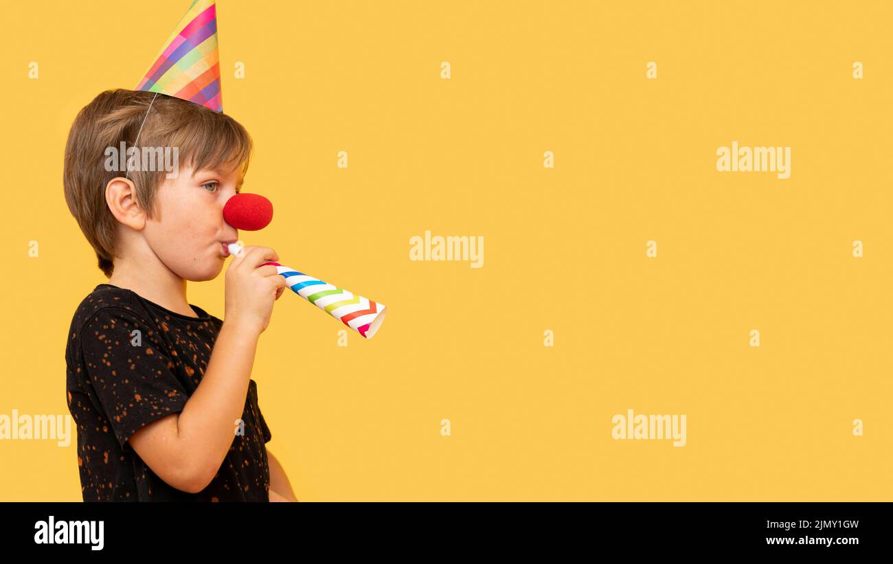 Side view boy wearing clown nose Stock Photo - Alamy