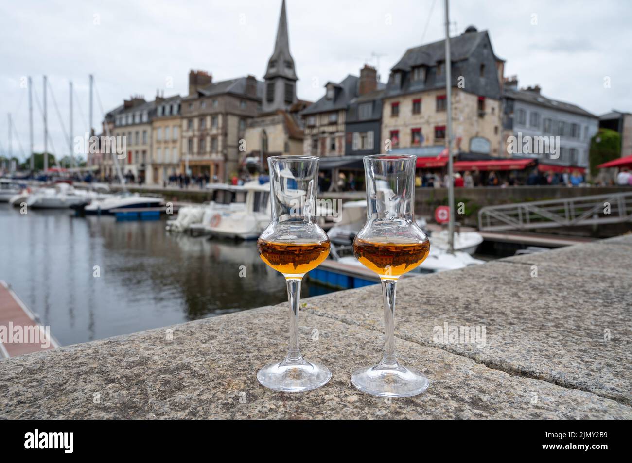 Tasting of apple calvados drink from glasses in old Honfleur harbour ...