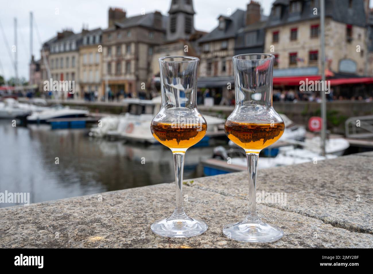 Tasting of apple calvados drink from glasses in old Honfleur harbour ...