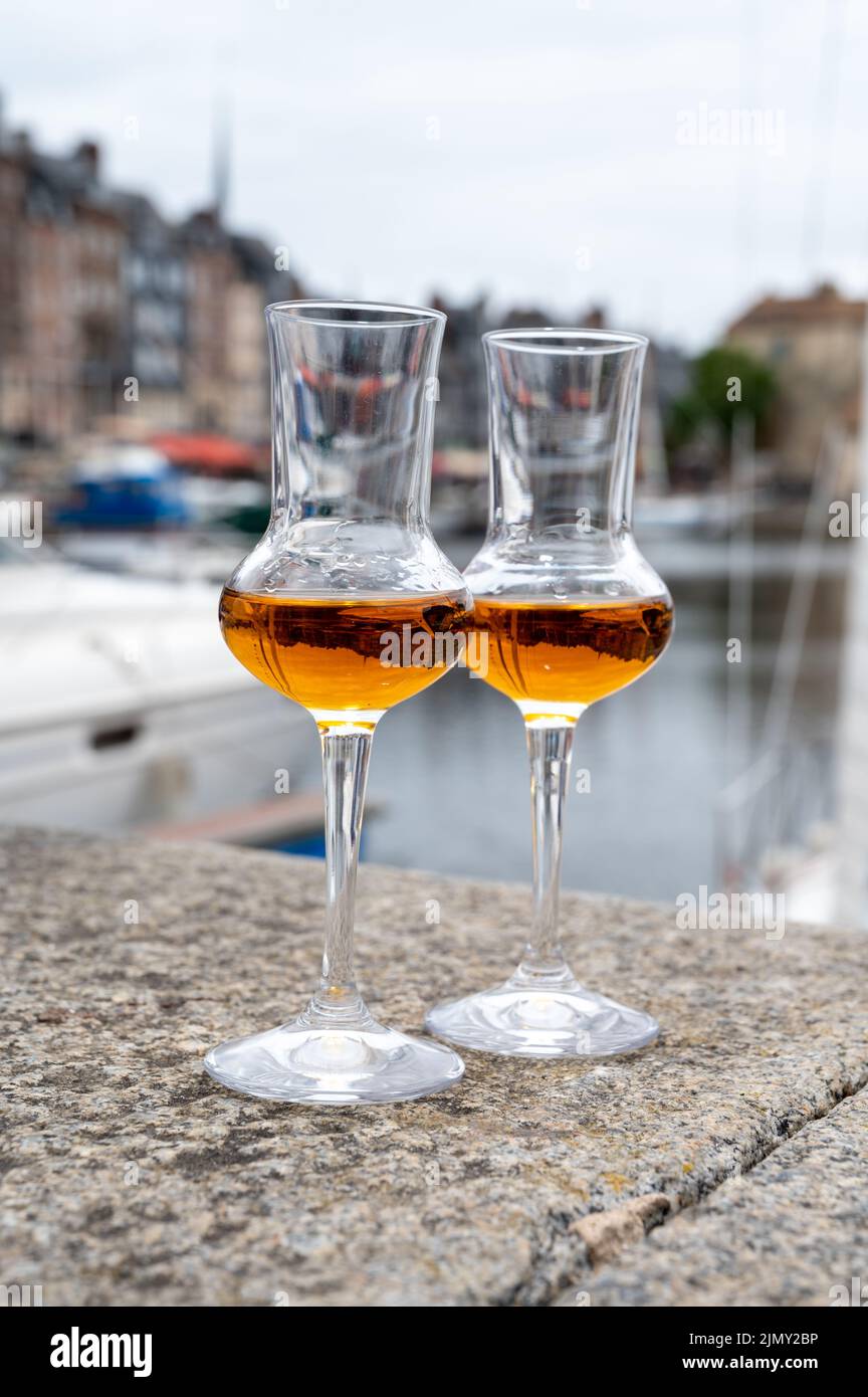 Tasting of apple calvados drink from glasses in old Honfleur harbour ...