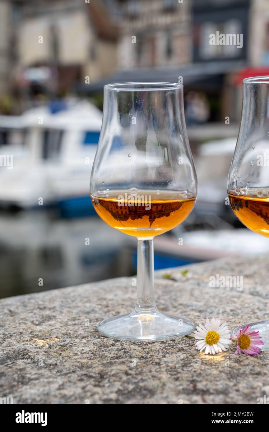 Tasting of apple calvados drink from glasses in old Honfleur harbour ...