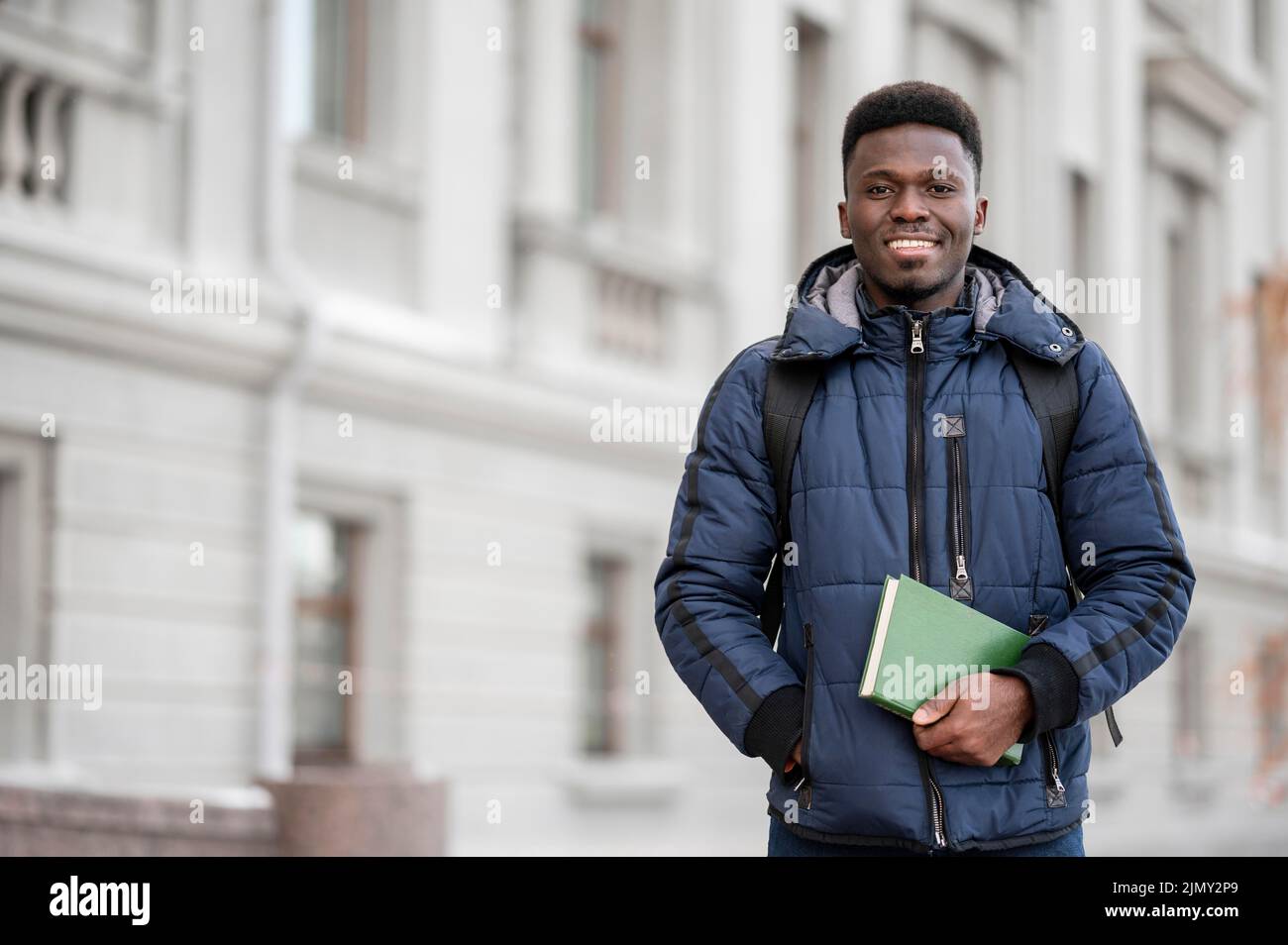 Portrait male student with books Stock Photo - Alamy