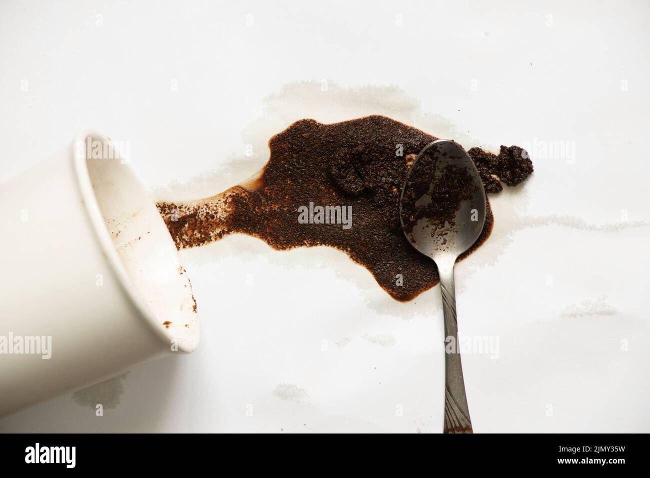 spilled coffee on white background, coffee grounds for background ...