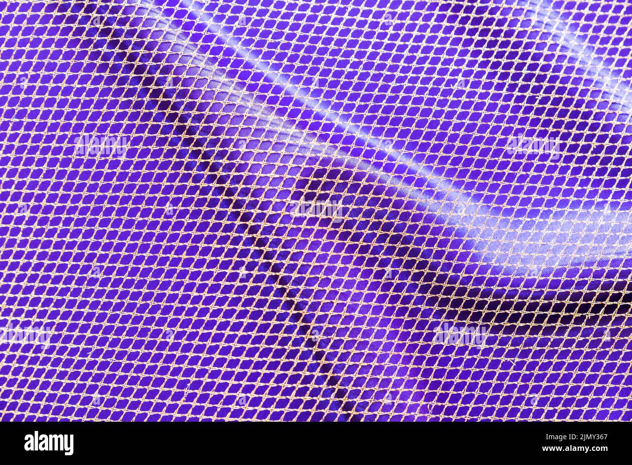 Purple mesh pattern fabric background Stock Photo - Alamy