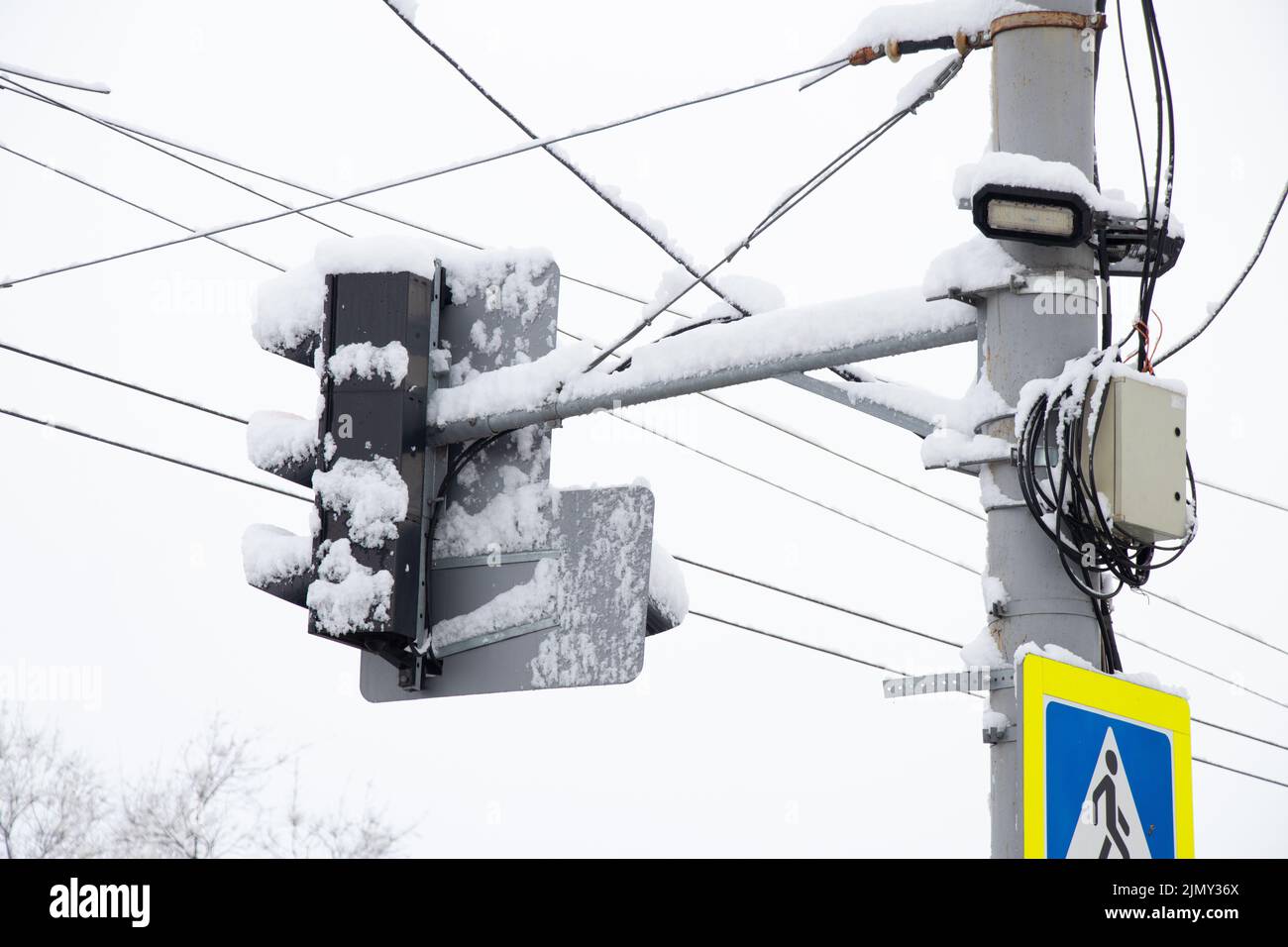 traffic light on the background of the sky in winter in snow and ice in ...