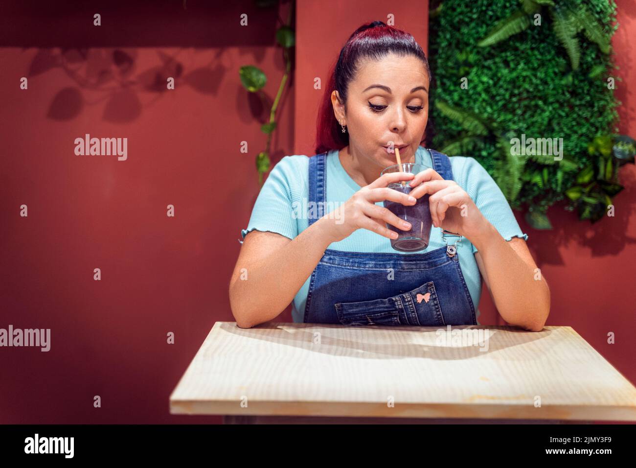 Young Woman Drinking A Fresh Smoothie While Sitting In A Cafe Healthy