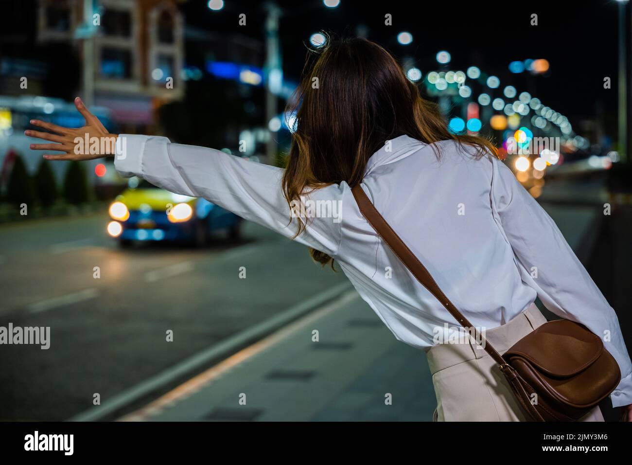 Back view, Beautiful woman smiling using smartphone application hailing ...