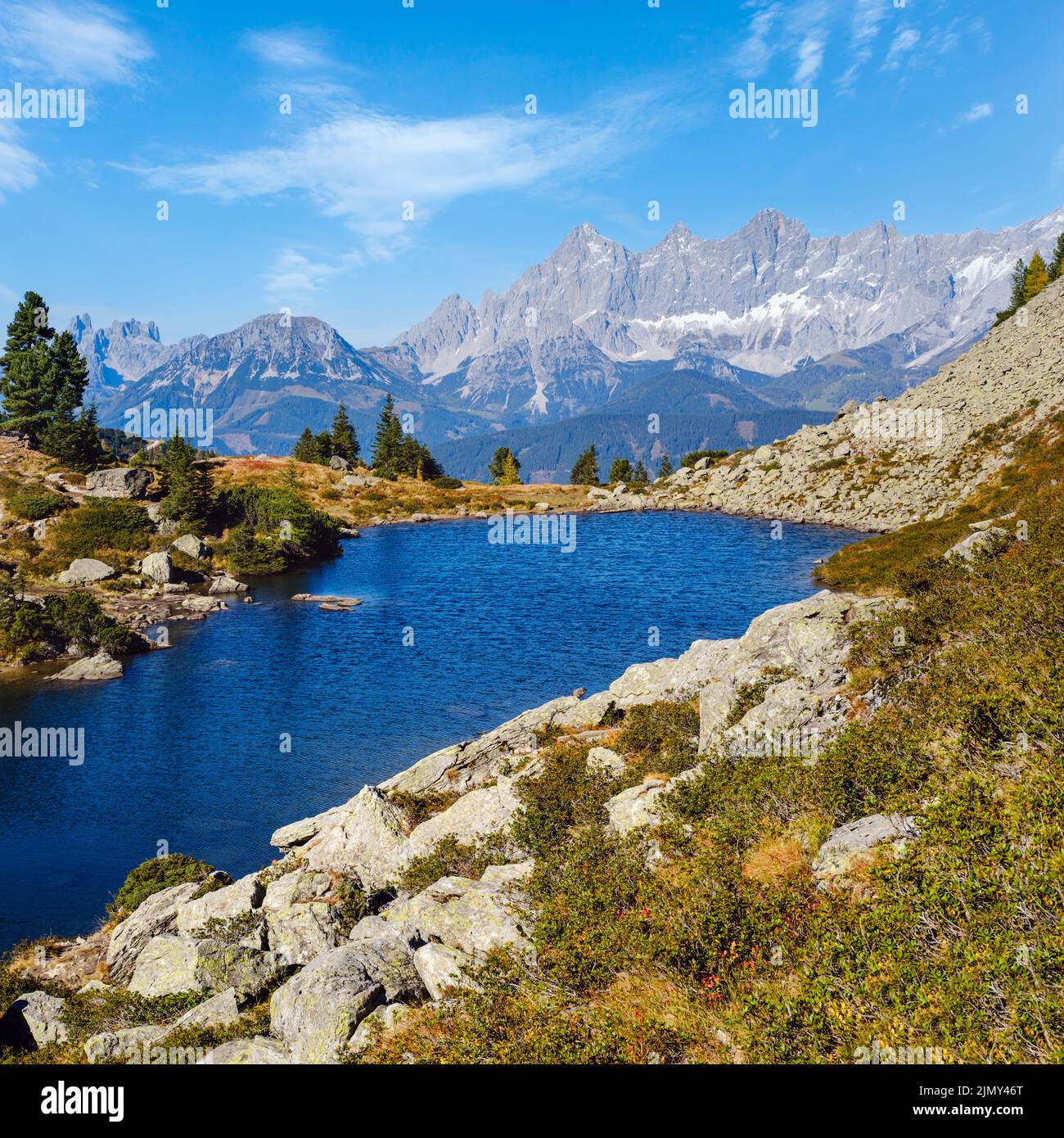Calm autumn Alps mountain lake with clear transparent water and ...