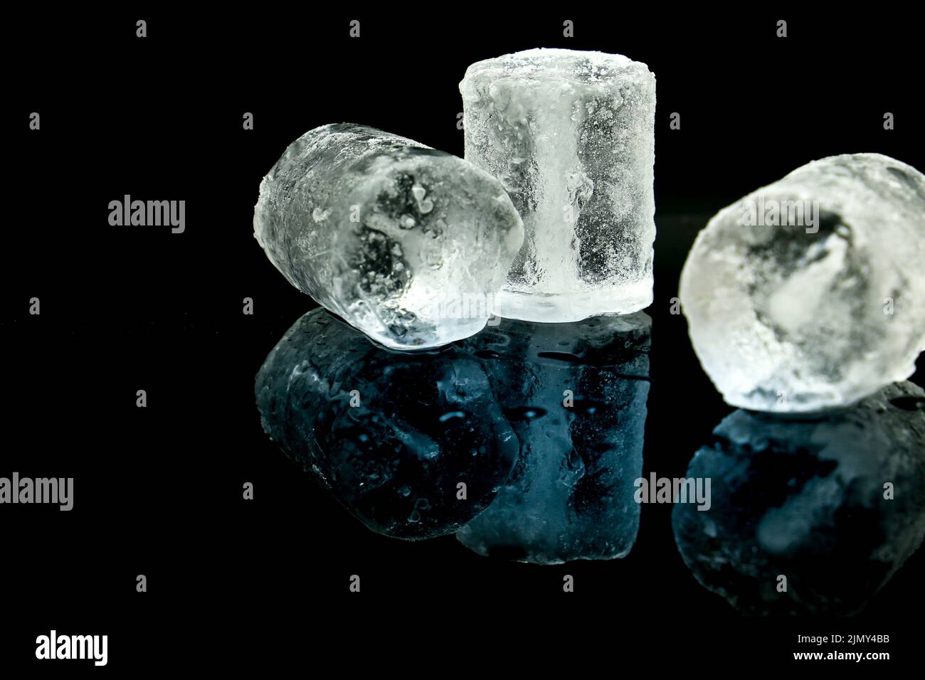 Big Ice cubes and reflections on black background Stock Photo - Alamy