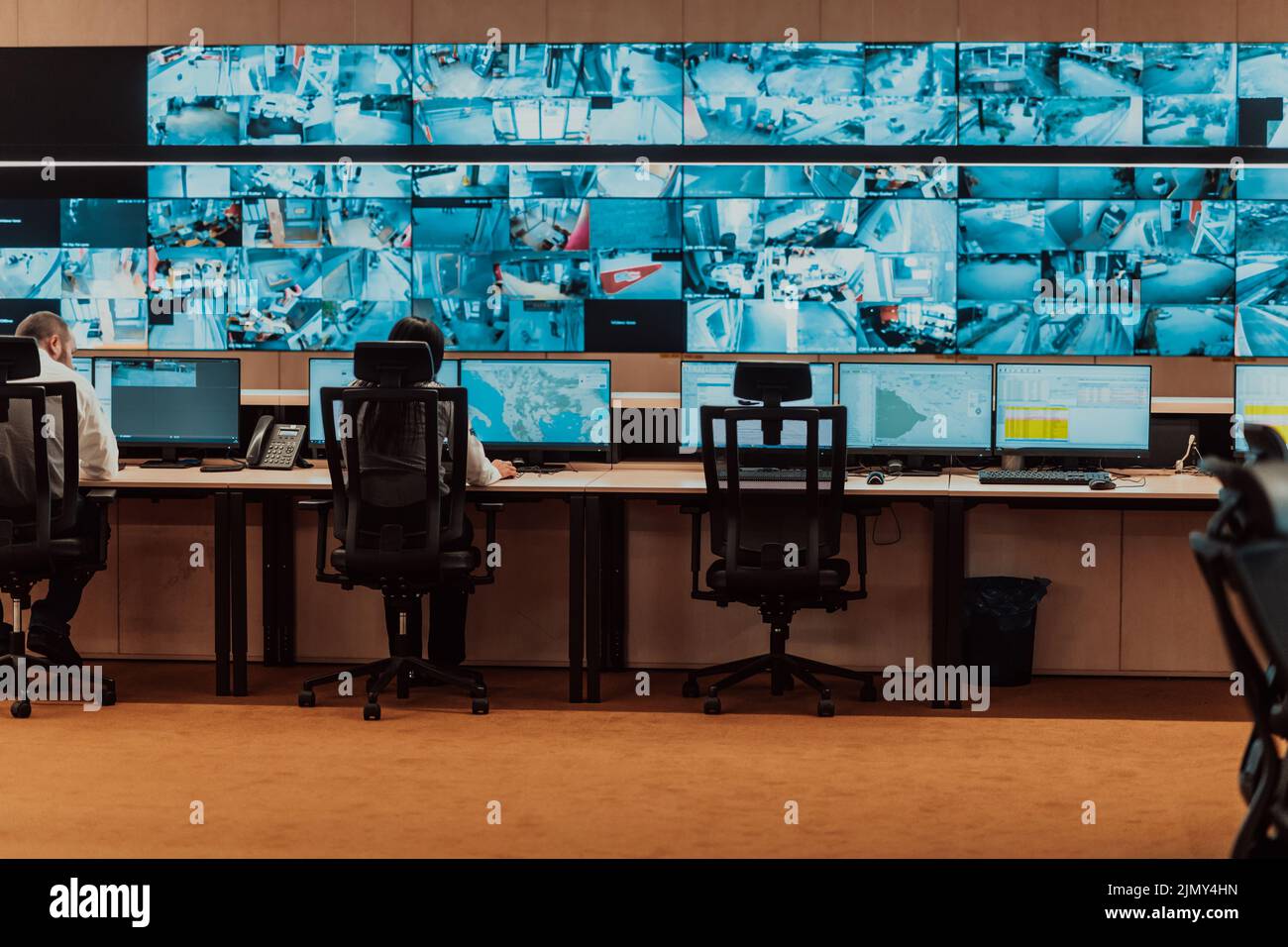 Empty interior of big modern security system control room, workstation ...
