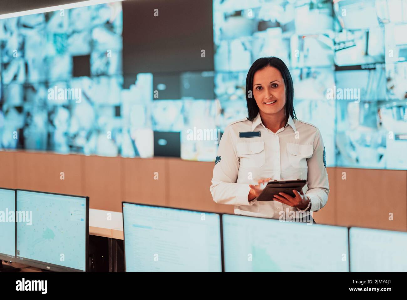 Portrait of female security operator while working in a data system ...