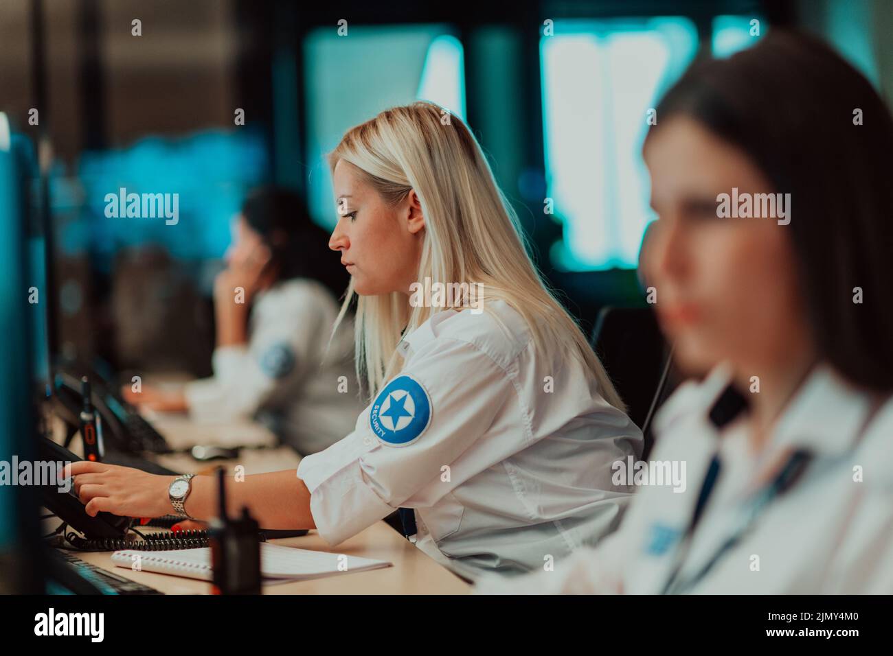 Female security operator working in a data system control room offices ...