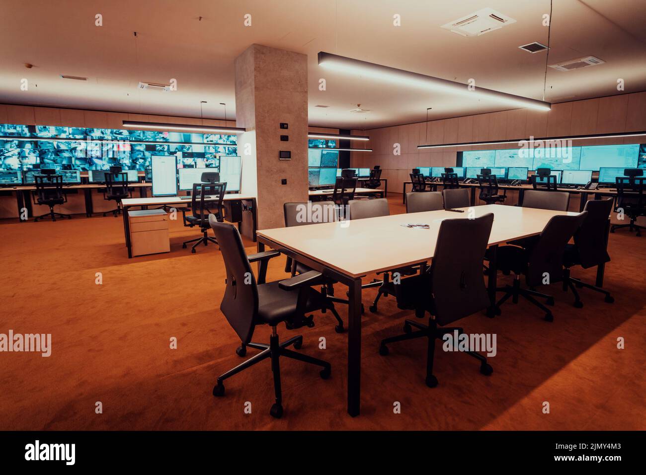 Empty interior of big modern security system control room, workstation ...