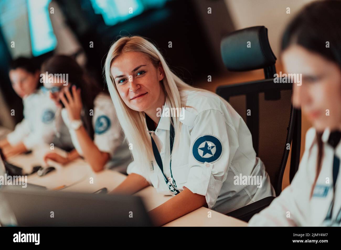 Female security operator working in a data system control room offices ...