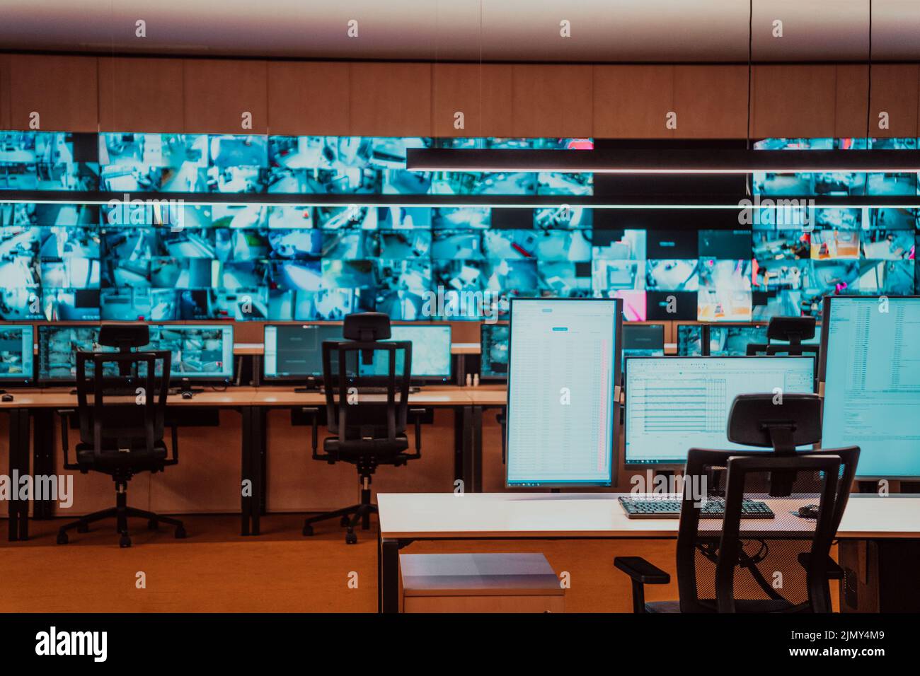Empty interior of big modern security system control room, workstation ...