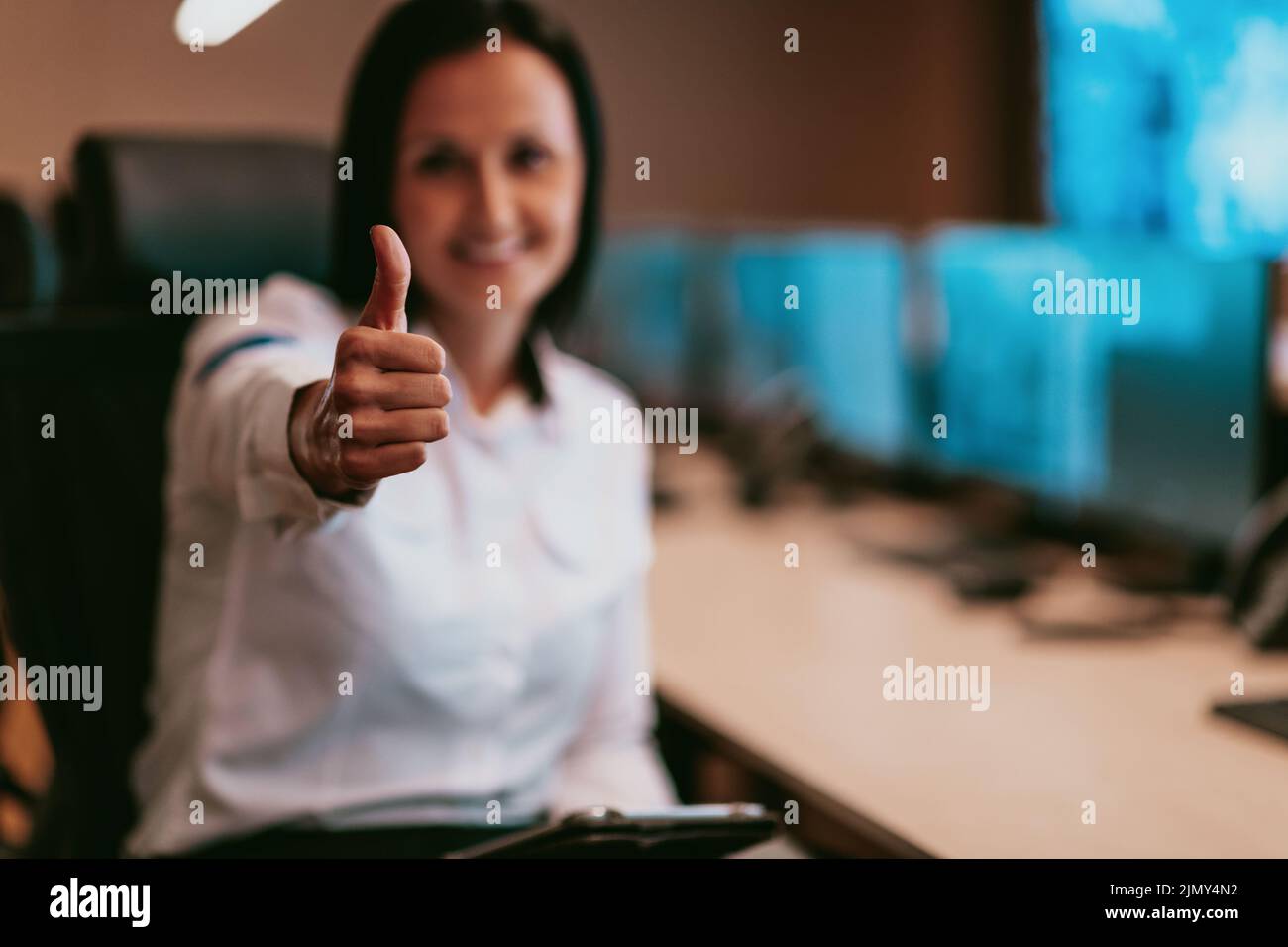 Portrait of female security operator while working in a data system ...