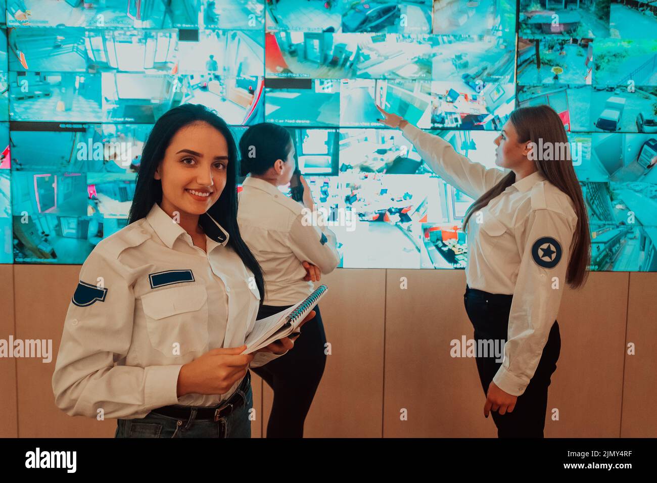 Group of female security operators working in a data system control ...