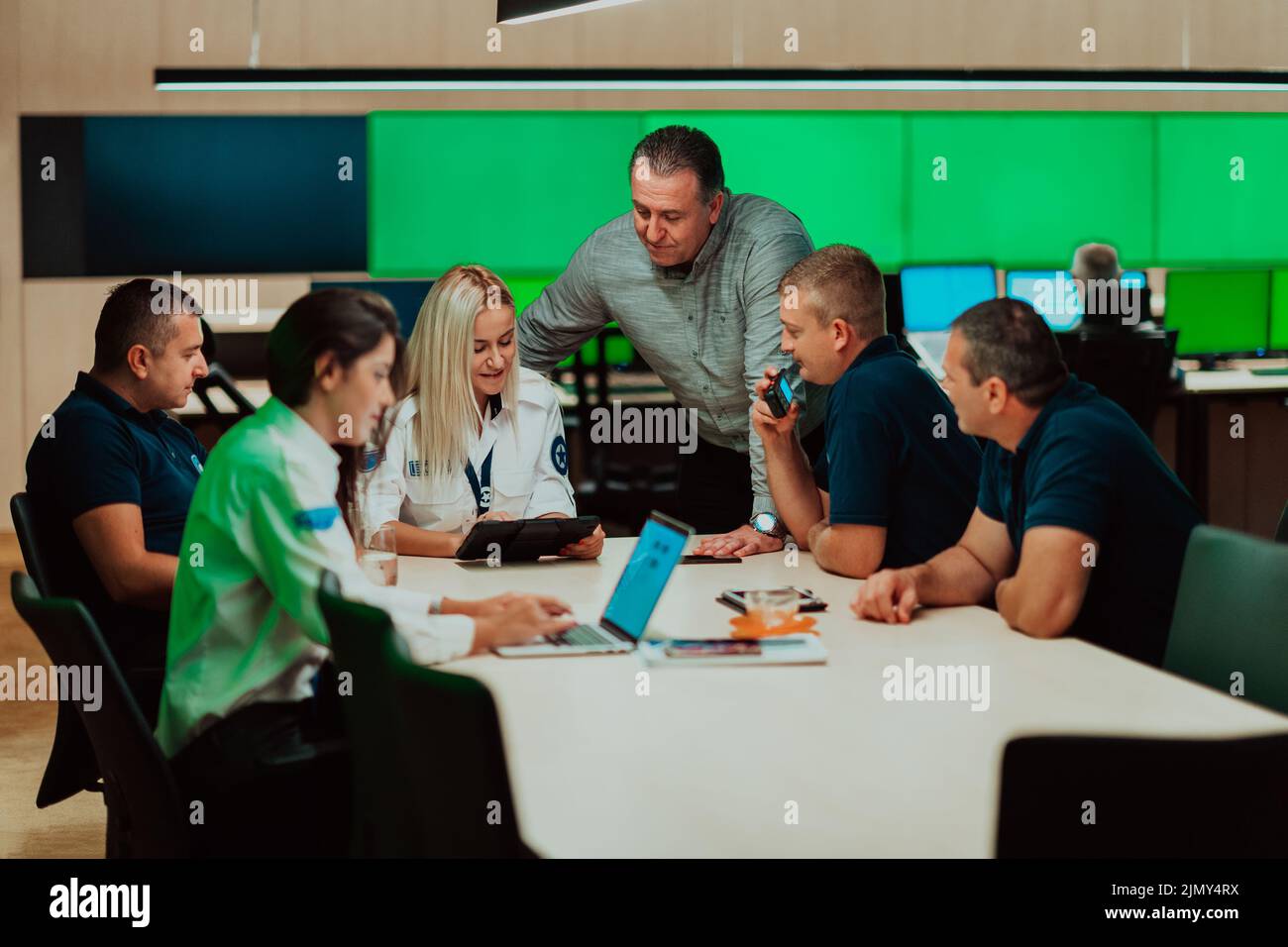 Group of security guards sitting and having briefing In the system ...