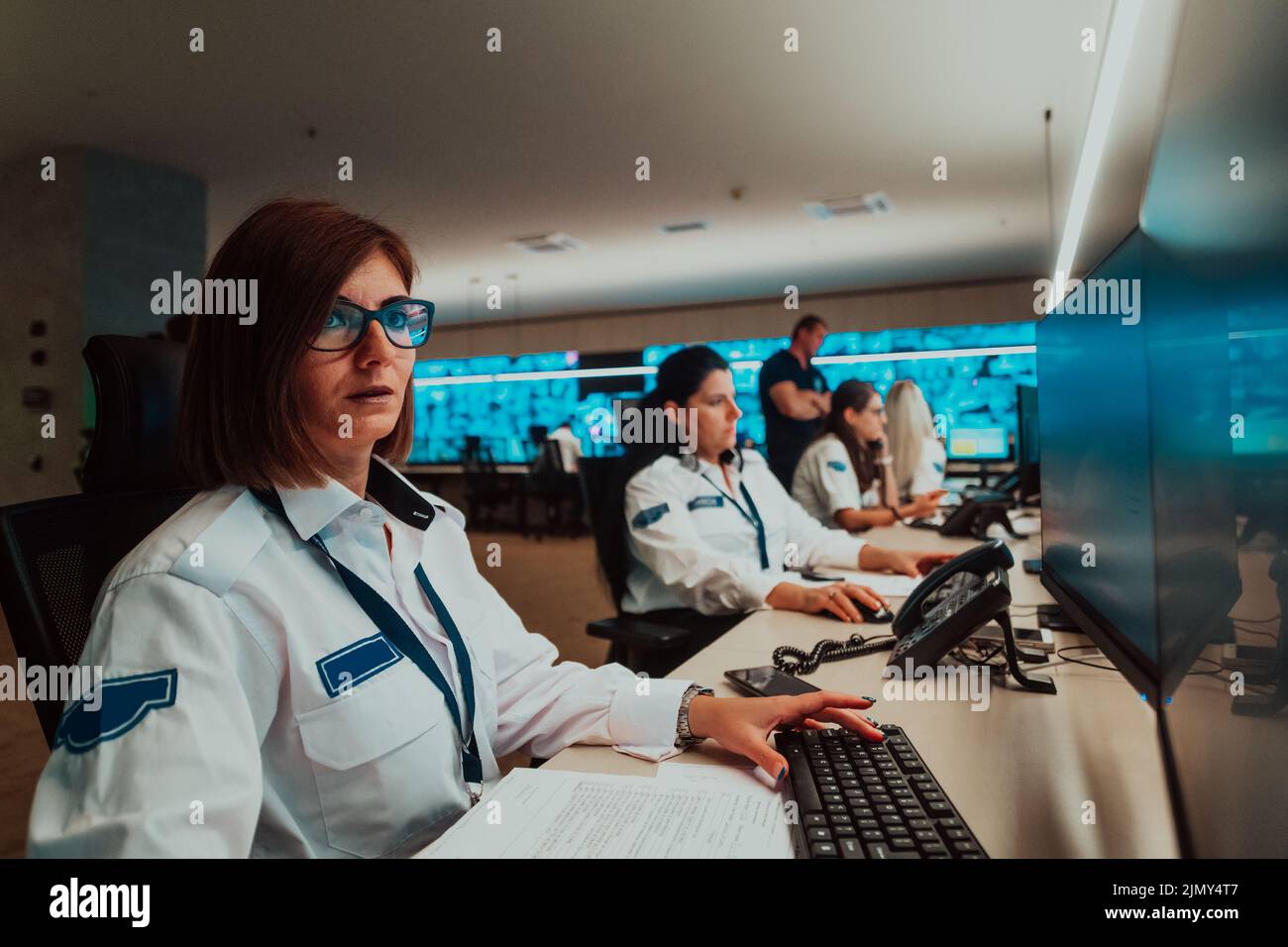 Group of female security operators working in a data system control ...