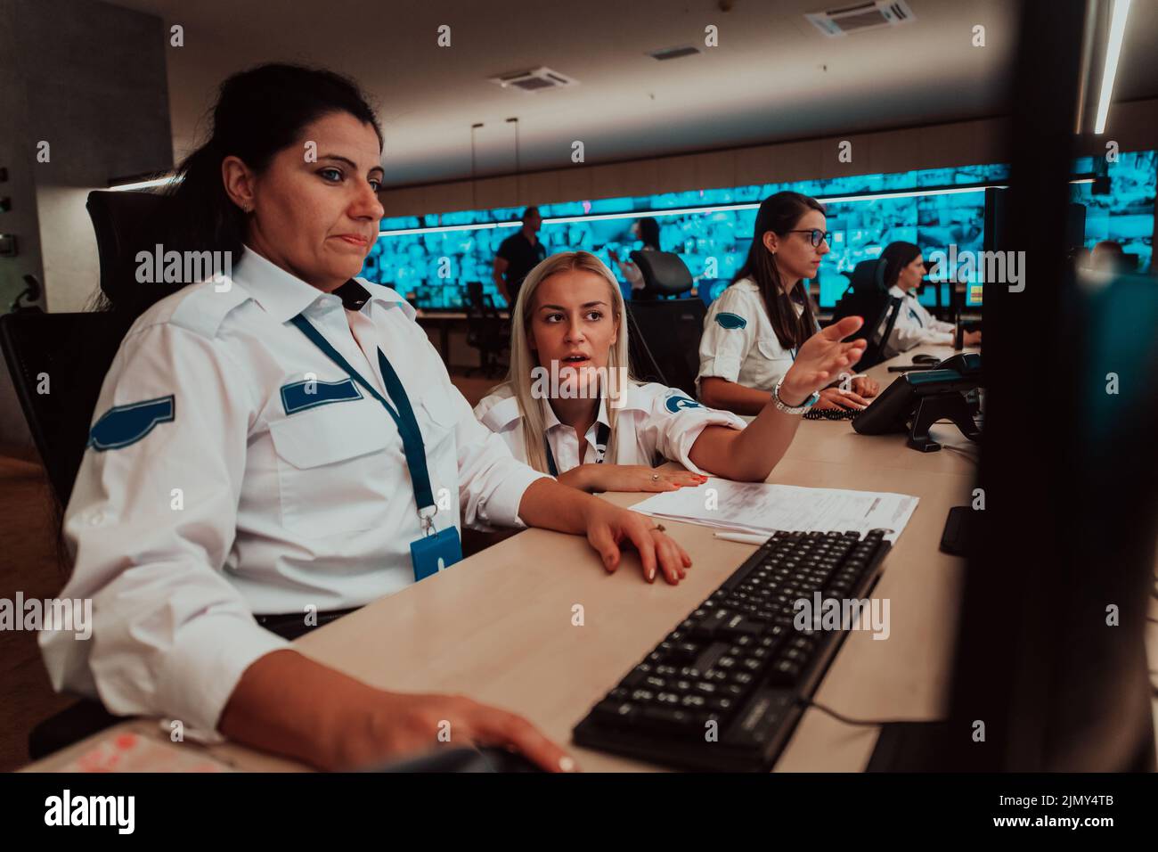 Group Of Female Security Operators Working In A Data System Control Room Technical Operators