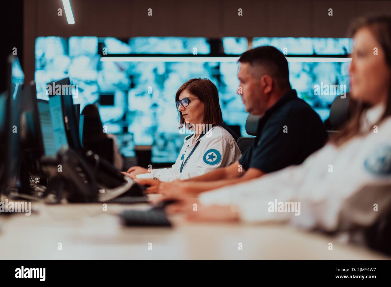 Group of Security data center operators working in a CCTV monitoring ...