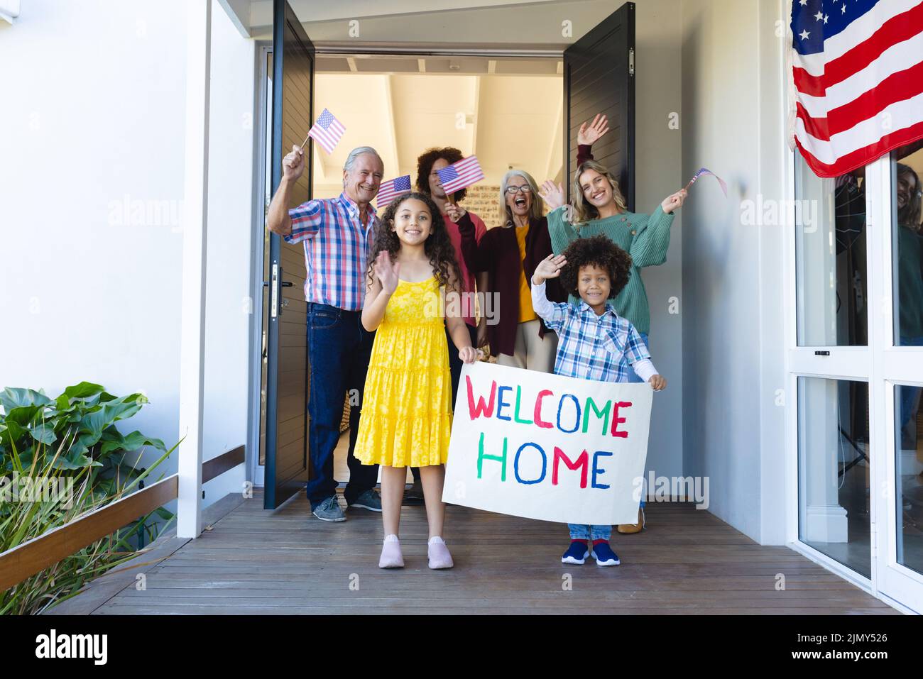 Multiracial cheerful multigeneration family with welcome home text and ...