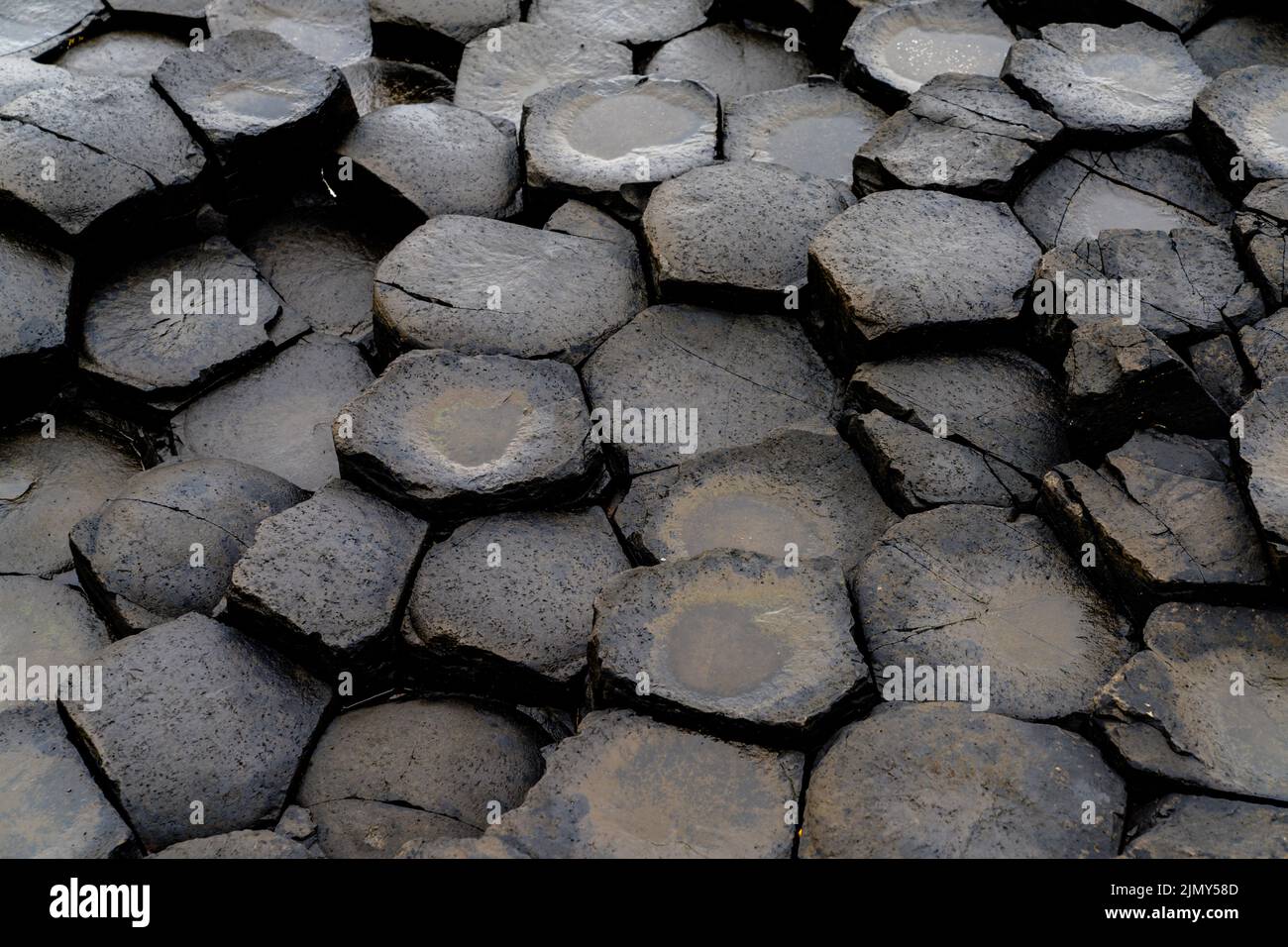 A close-up detail view of the volcanic hexagon basalt rock columns of ...