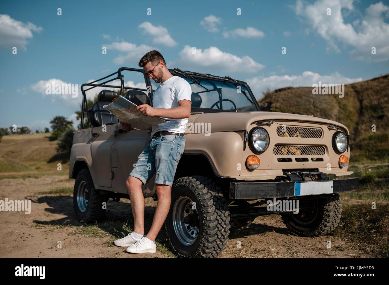 Man holding map while traveling by car Stock Photo - Alamy
