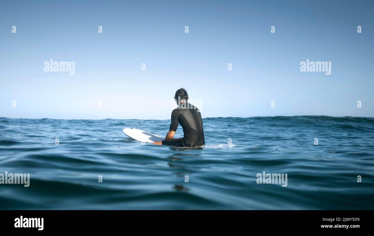 Man sitting water from back shot Stock Photo - Alamy