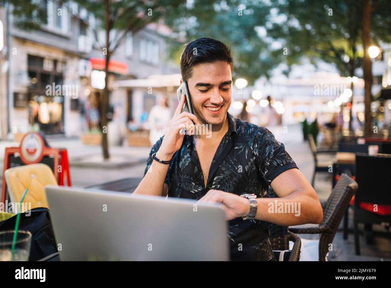 Happy man looking time wrist watch while talking cellphone Stock Photo ...