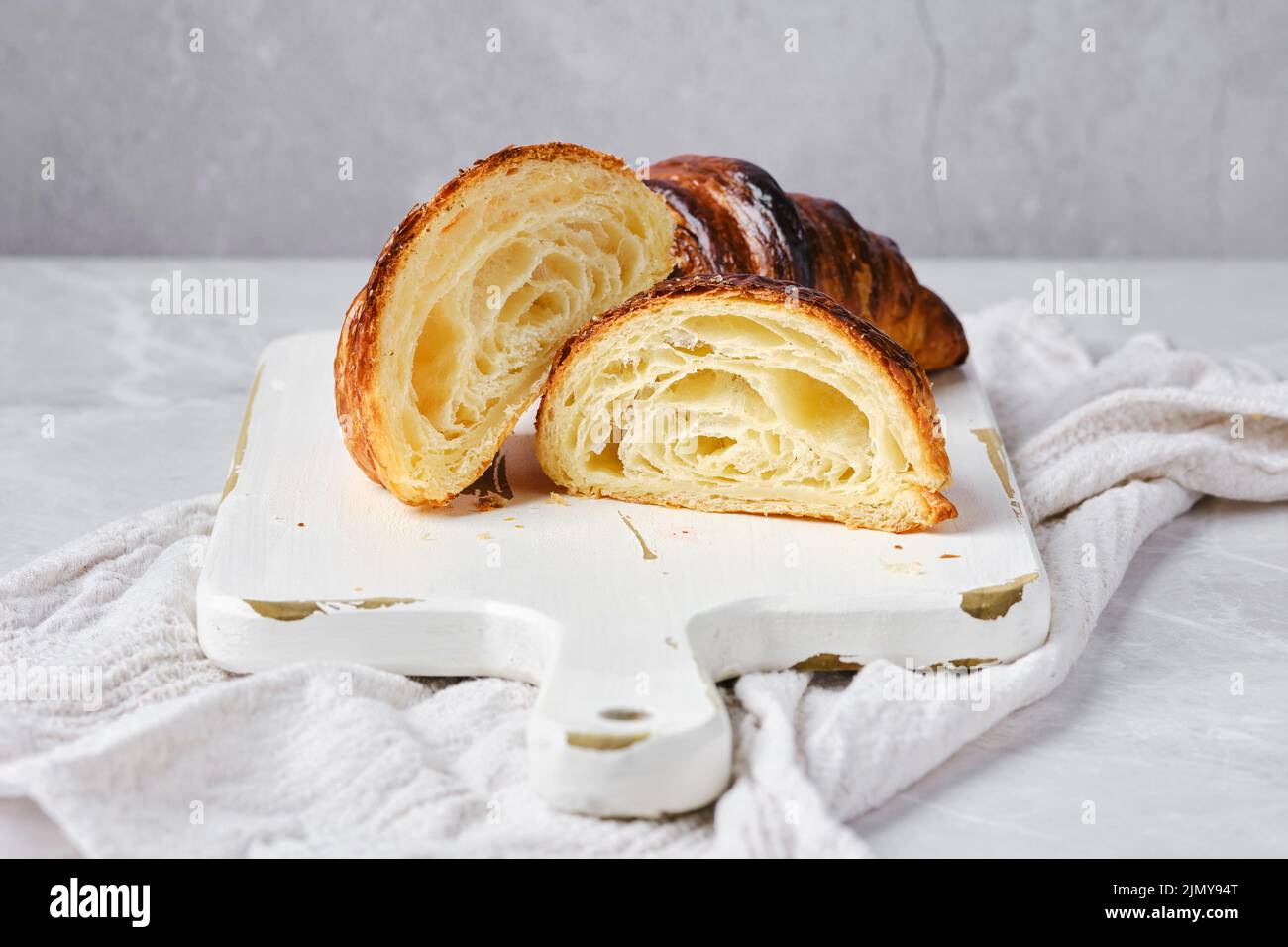 Cross section of classic croissant on marble background and white ...