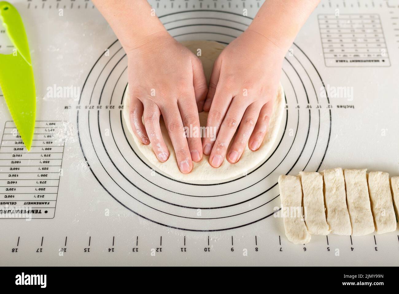 Top view of the cooking process on a silicone baking mat with markings ...