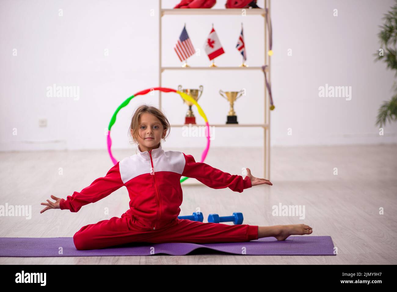 Young little girl doing sport exercises at home Stock Photo - Alamy