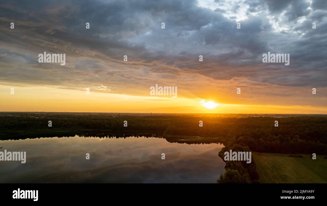 Aerial view, shot by a drone of a sunset at coast of the lake. Nature ...