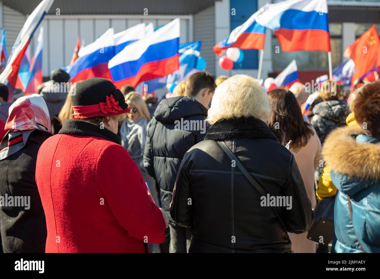 People with Russian flags are walking down street. Russian citizens at ...