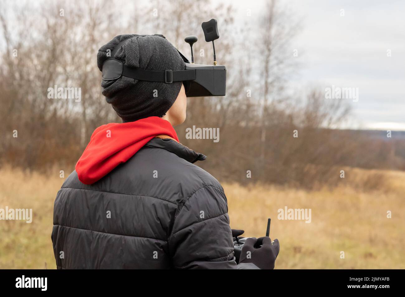 Young man launches rc plane into sky. Teenager with glasses playing ...