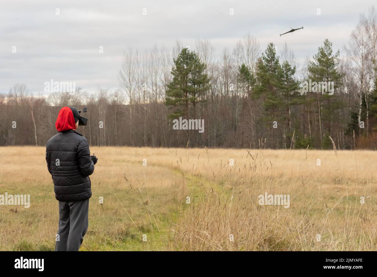 Young man launches rc plane into sky. Teenager with glasses playing ...