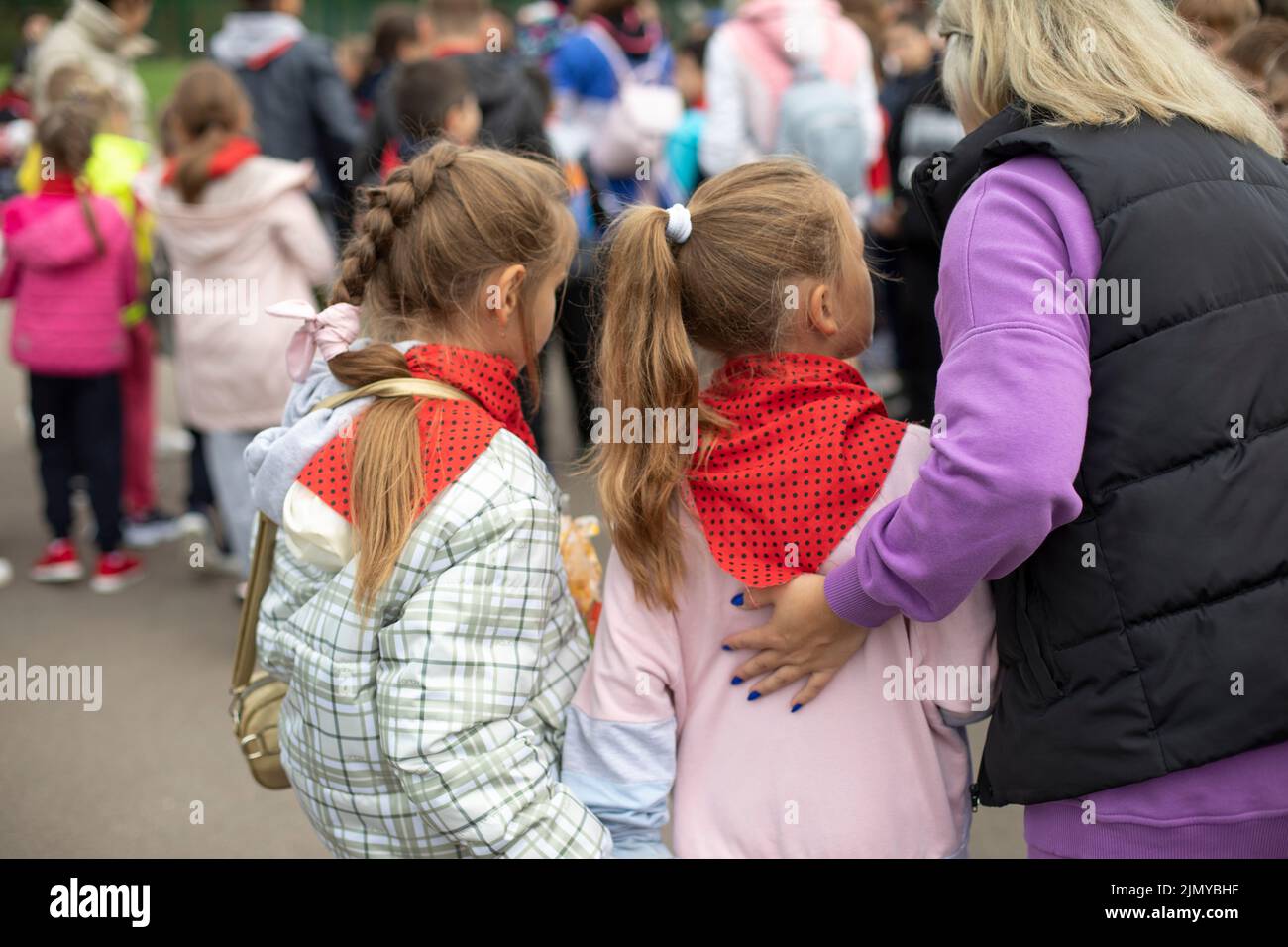 Mother and daughters on street. Mom explains to her daughter. Children ...