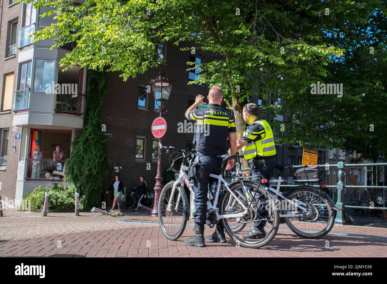 Two Police Men On Bicycles At Amsterdam The Netherlands 6-8-2022 Stock ...