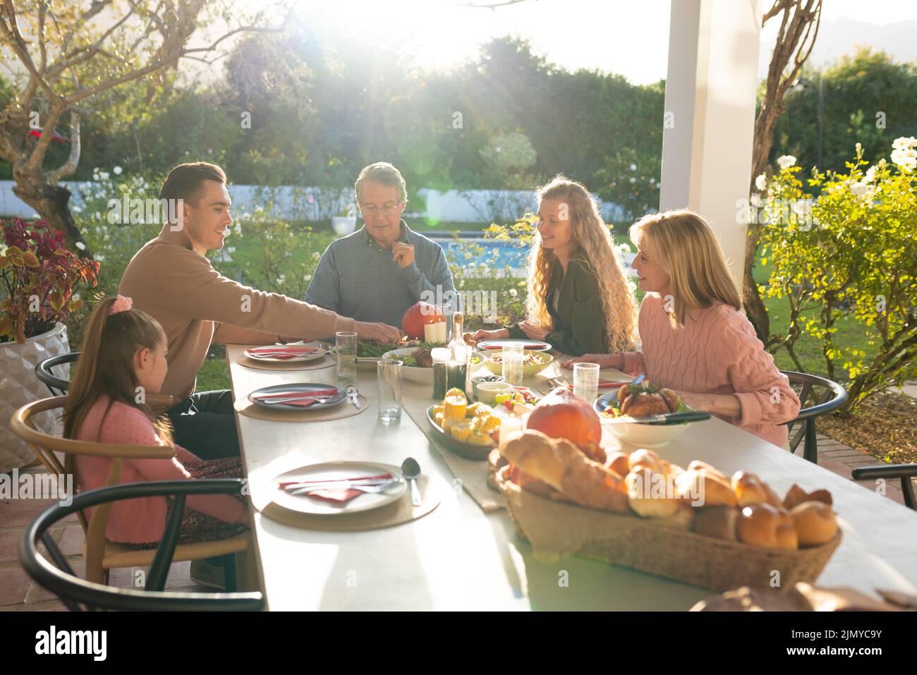 Image of multi generation caucasian family eating outdoor dinner Stock ...