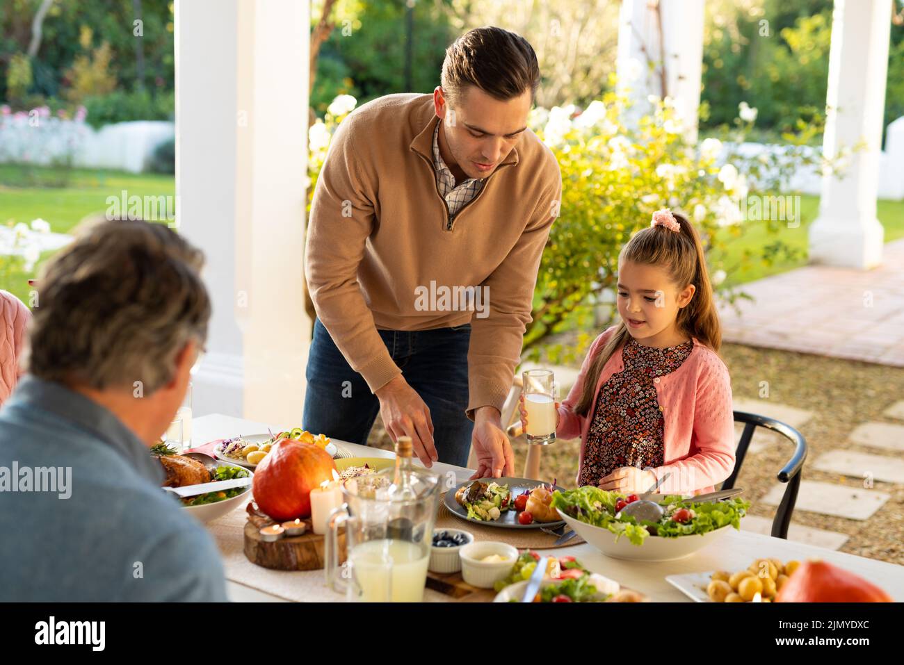 Image of multi generation caucasian family eating outdoor dinner Stock ...