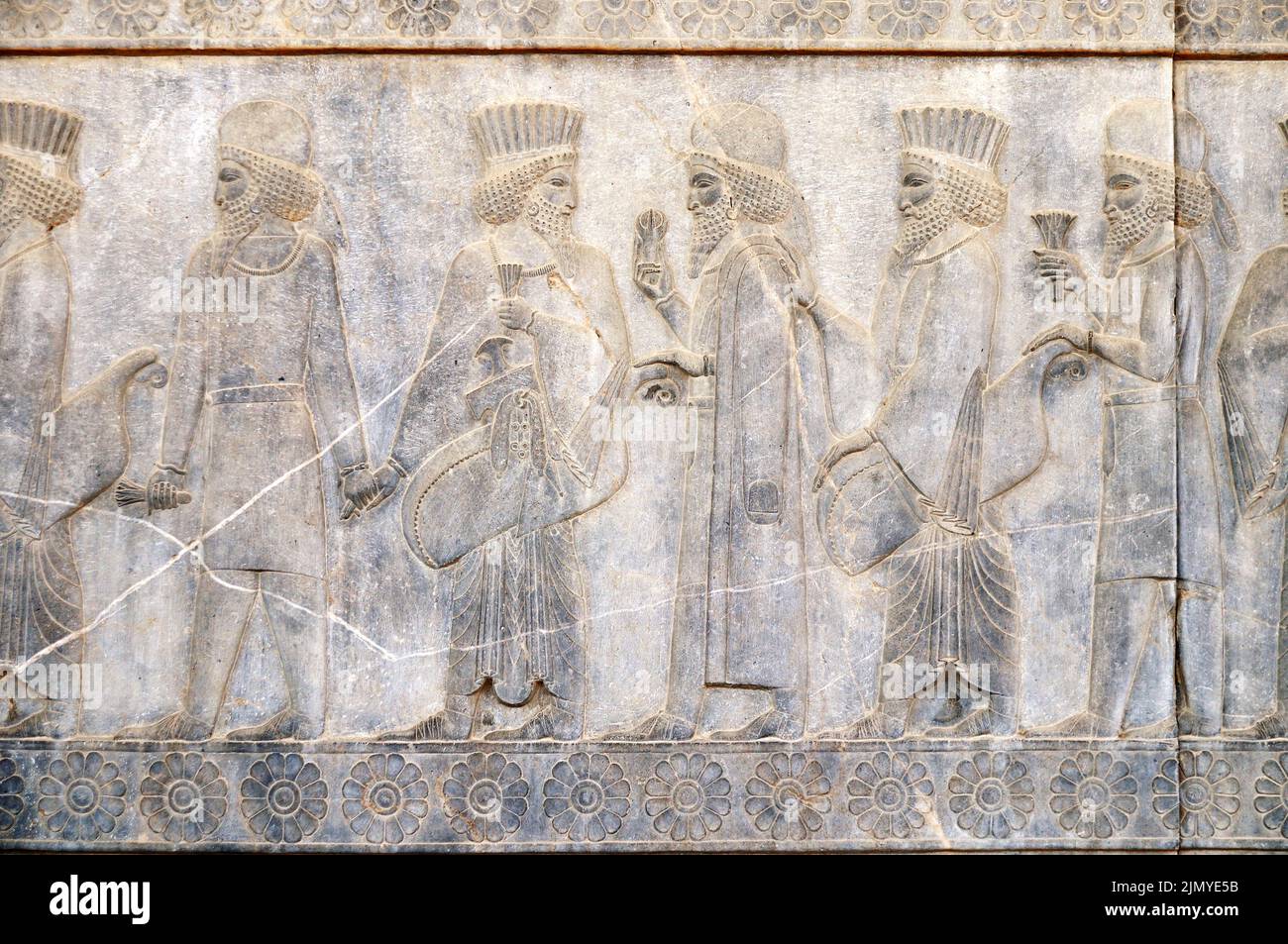 Ancient wall with bas-relief with assyrian foreign ambassadors with ...