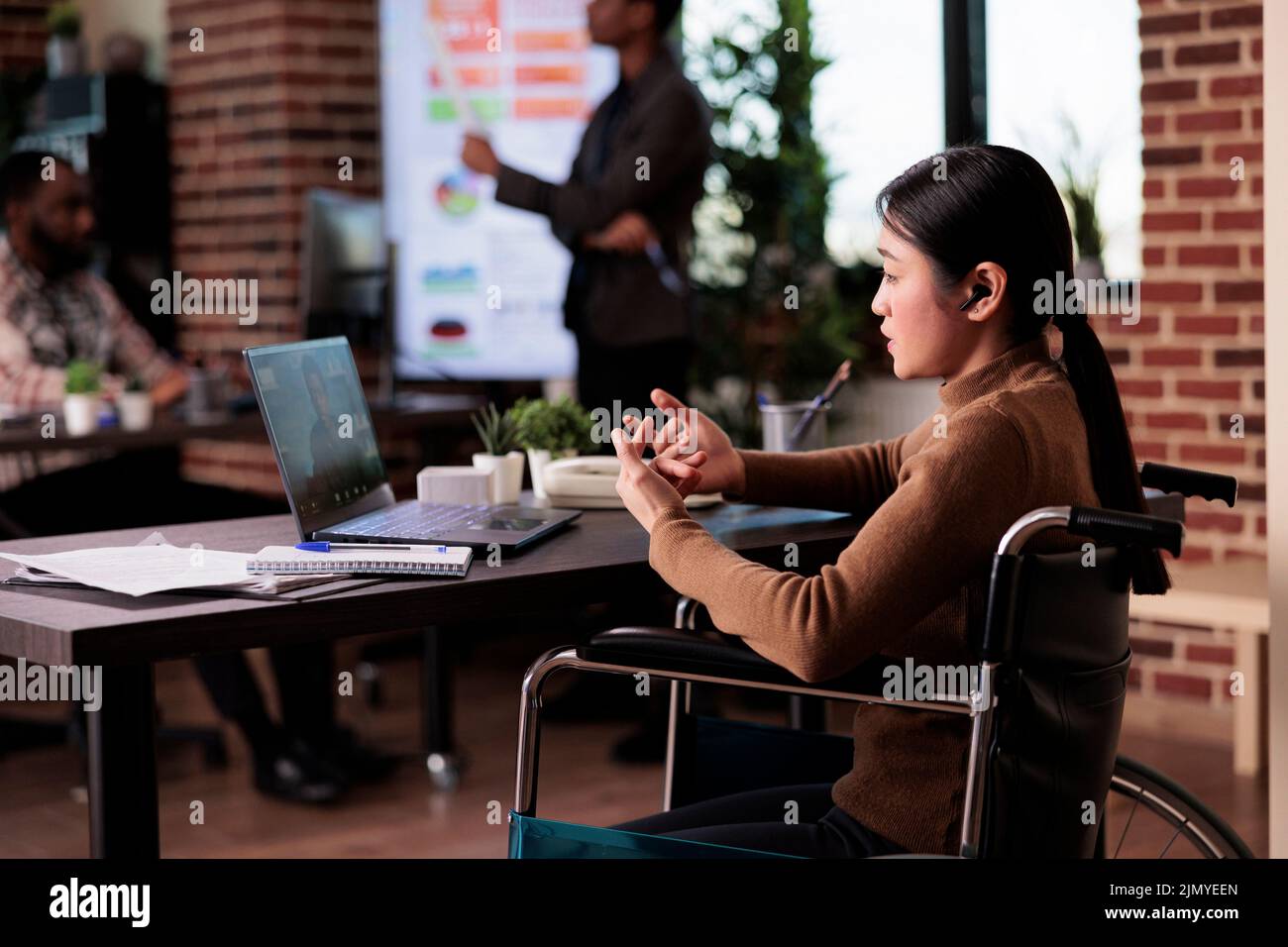 Worker with chronic impairment using remote teleconference chat on ...