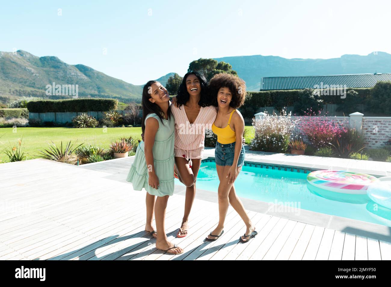 Portrait of biracial female friends laughing, posing and hanging out at ...
