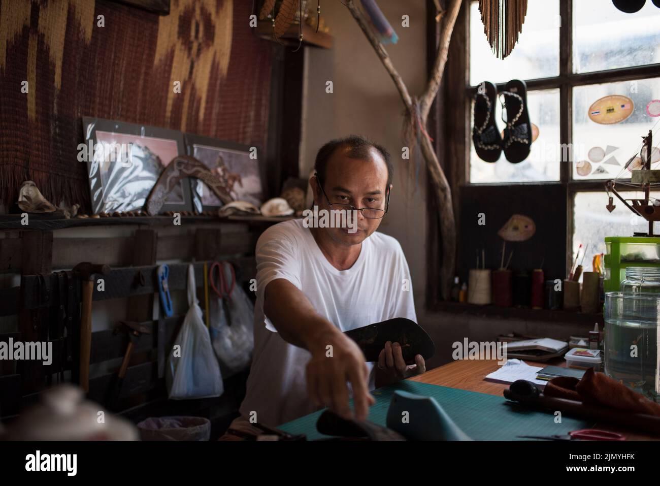 Local shoe shop. Shoe production workshop. Portrait of the shoemaker ...