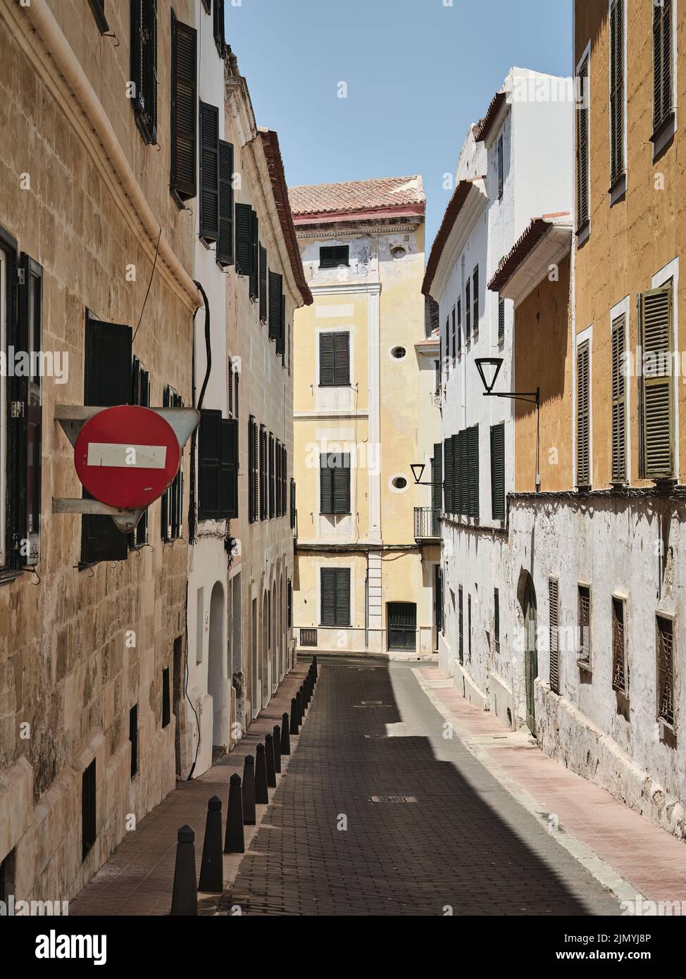 One-way narrow street in Mahon, Menorca, Spain Stock Photo - Alamy