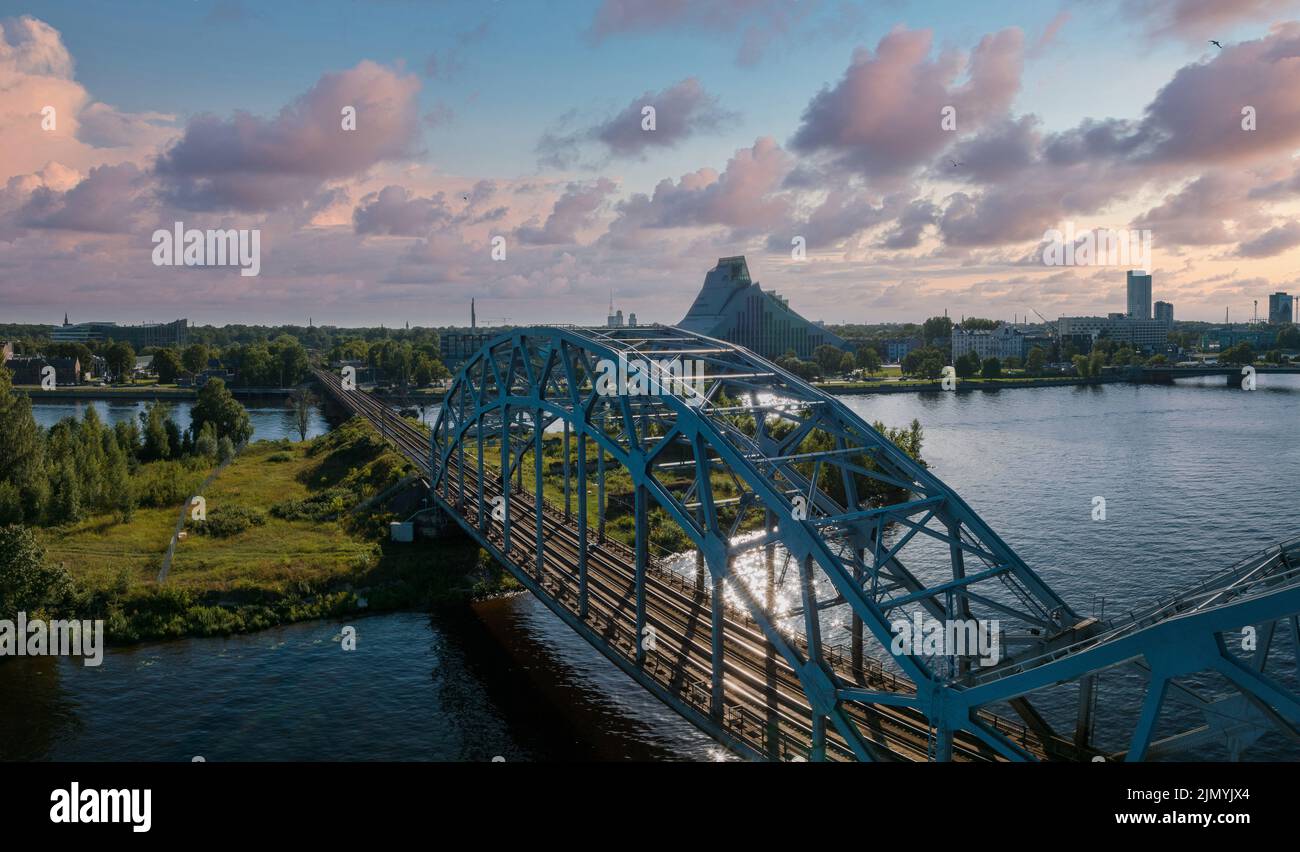 A bridge over river Daugava in Riga with a train passing by Stock Photo ...