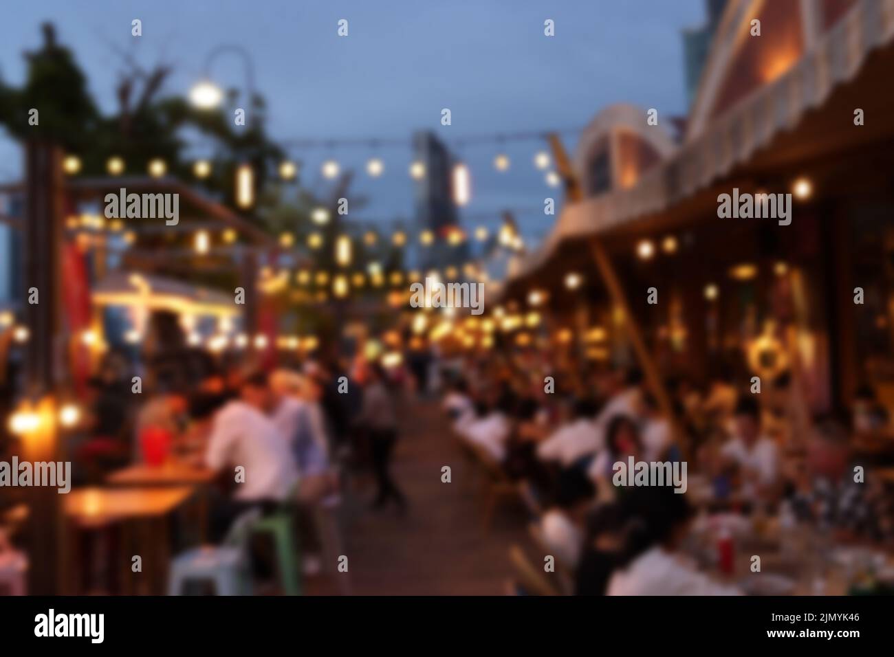 blurred image at the restaurant night time, many people in the ...
