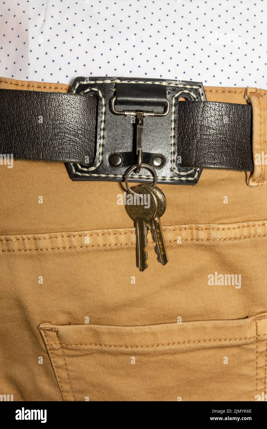 leather key strap with iron carabiner with two keys mounted on a leather belt Stock Photo - Alamy