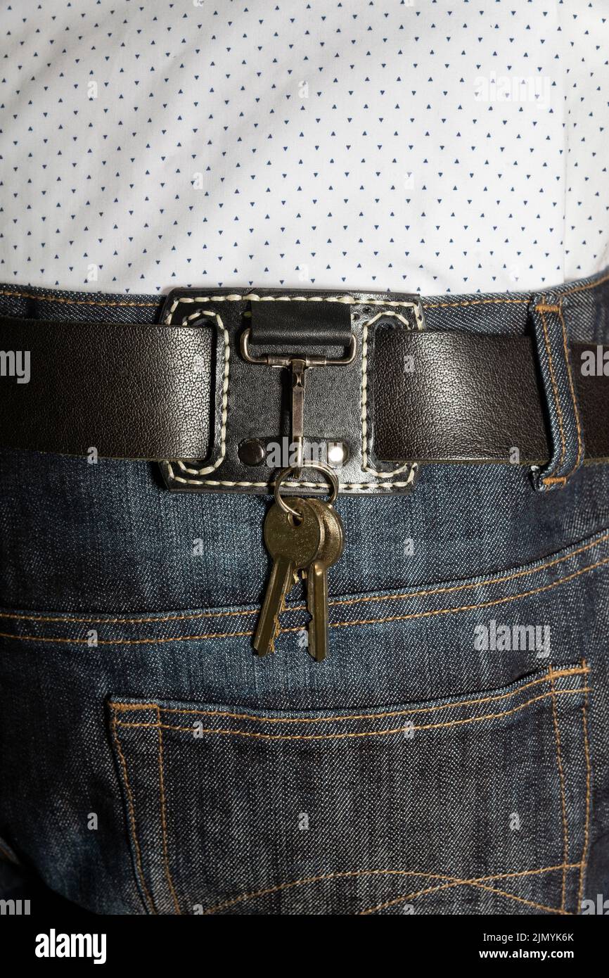 leather key strap with iron carabiner with two keys mounted on a leather belt Stock Photo - Alamy